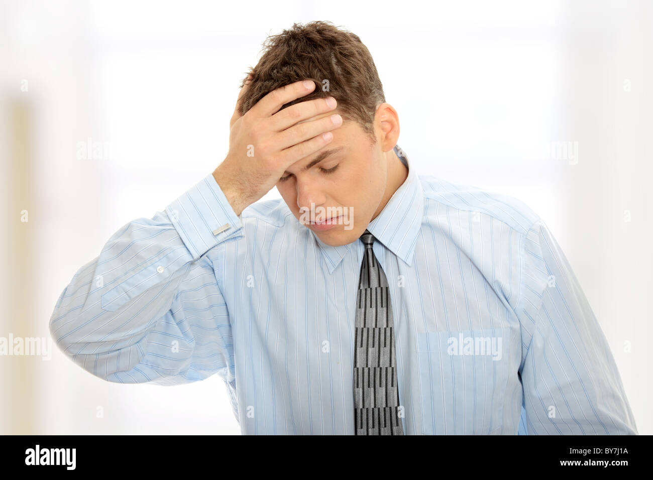 Businessman with a big headache Stock Photo - Alamy