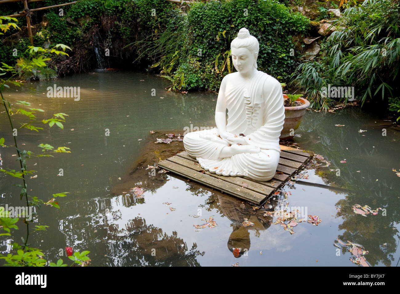 floating white stone buddha on a platform in Andre Heller Botanical ...