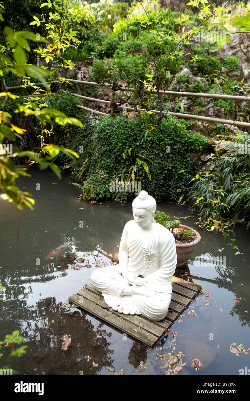 floating white stone buddha on a platform in Andre Heller Botanical ...