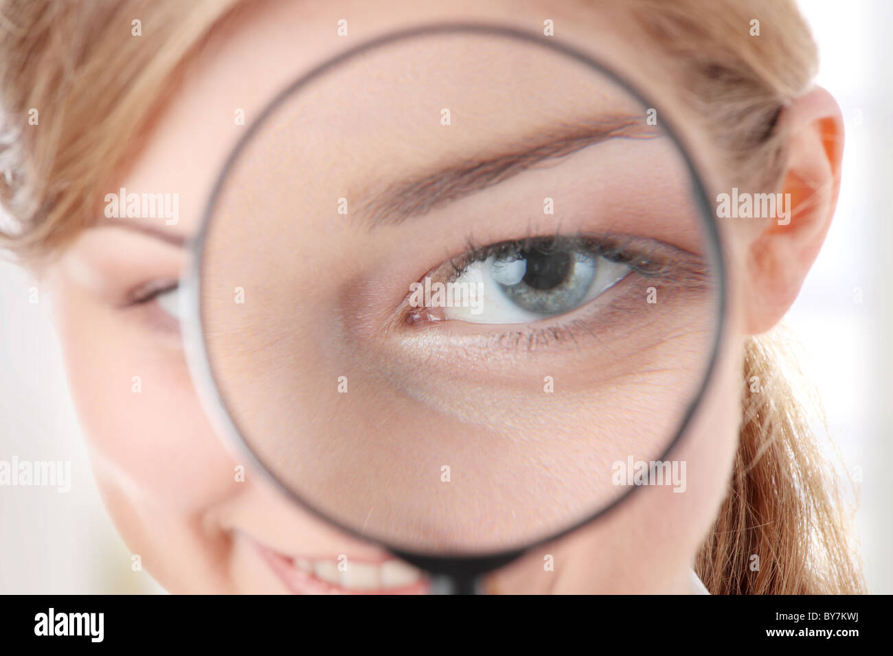 The woman with a magnifier in a hand Stock Photo - Alamy