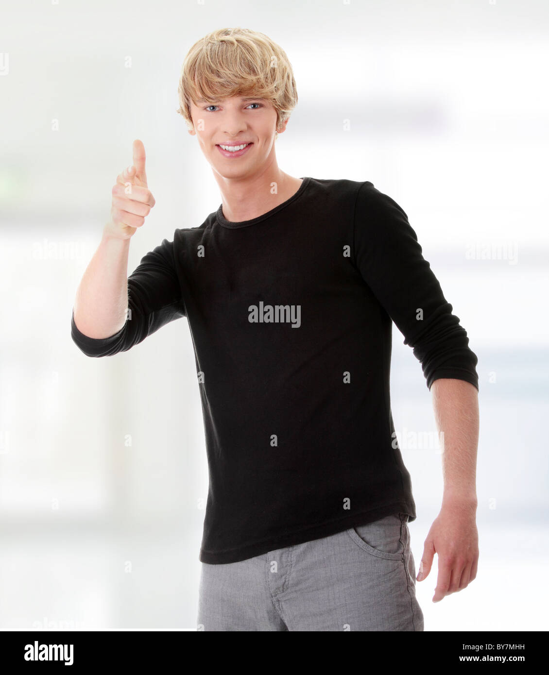 Portrait of a young man smiling, pointing at you Stock Photo - Alamy