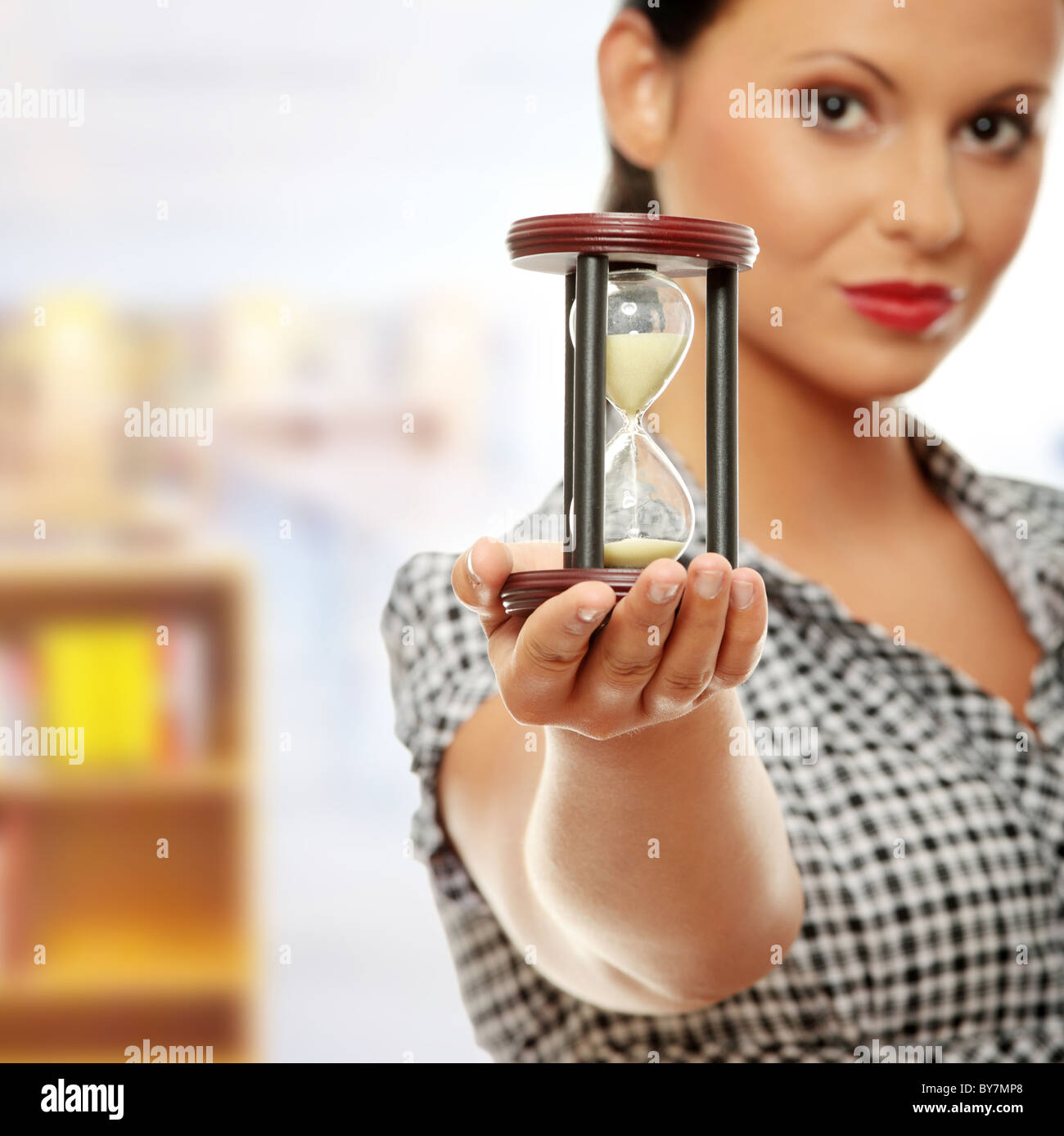 Young business woman with hourglass - time concept Stock Photo - Alamy