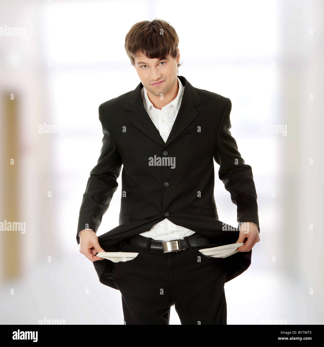 Sad and broke business man with empty pockets Stock Photo - Alamy