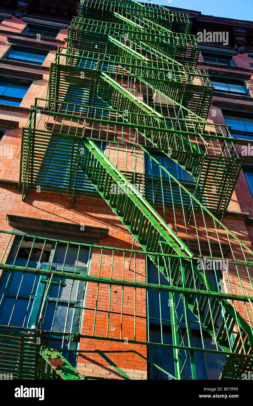 New York Tenement block with green fire escape Stock Photo - Alamy