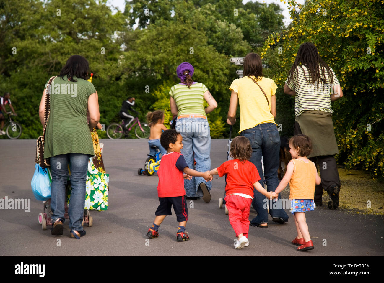 Group of parents and children walking in London Park Stock Photo - Alamy