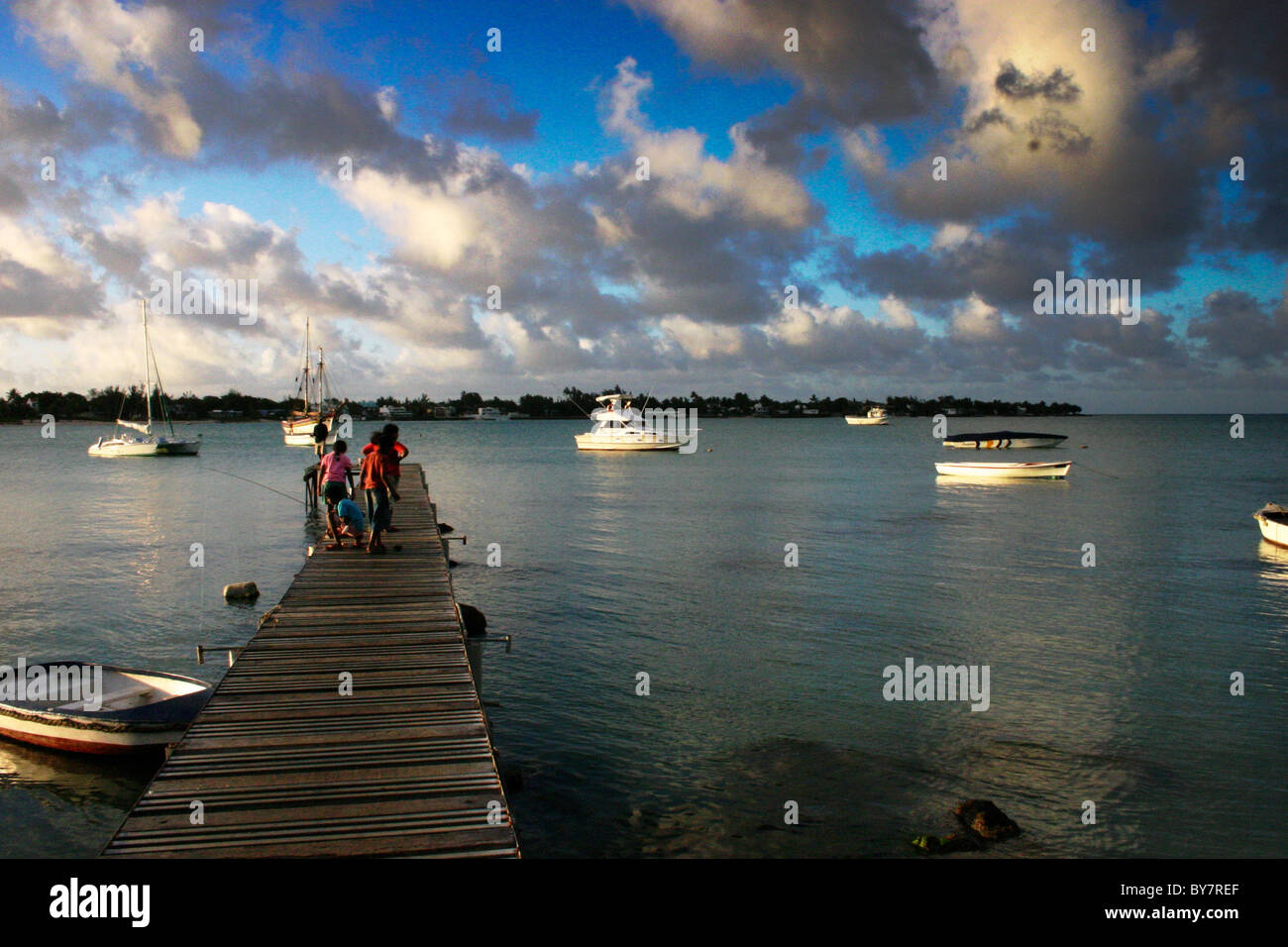 Children on the peer, Boats, Sea, Water, Sunset, Mauritius Stock Photo ...