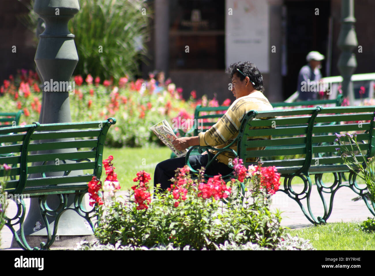 Taking a break on a bench in the Plaza de Armas Stock Photo - Alamy