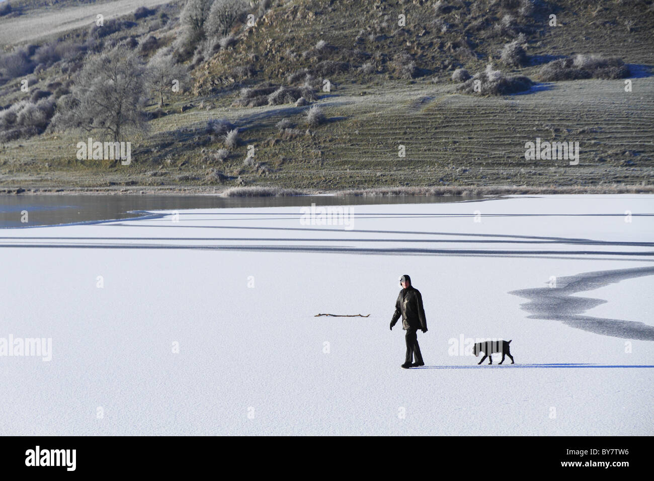 Winter walking on the frozen lake of lough Gur, Co Limerick, Republic ...