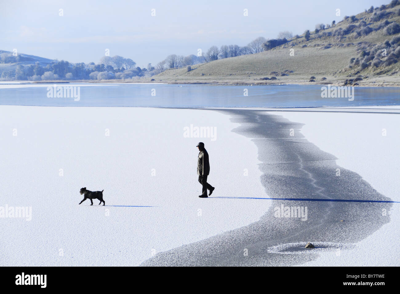 Winter walking on the frozen lake of lough Gur, Co Limerick, Republic ...