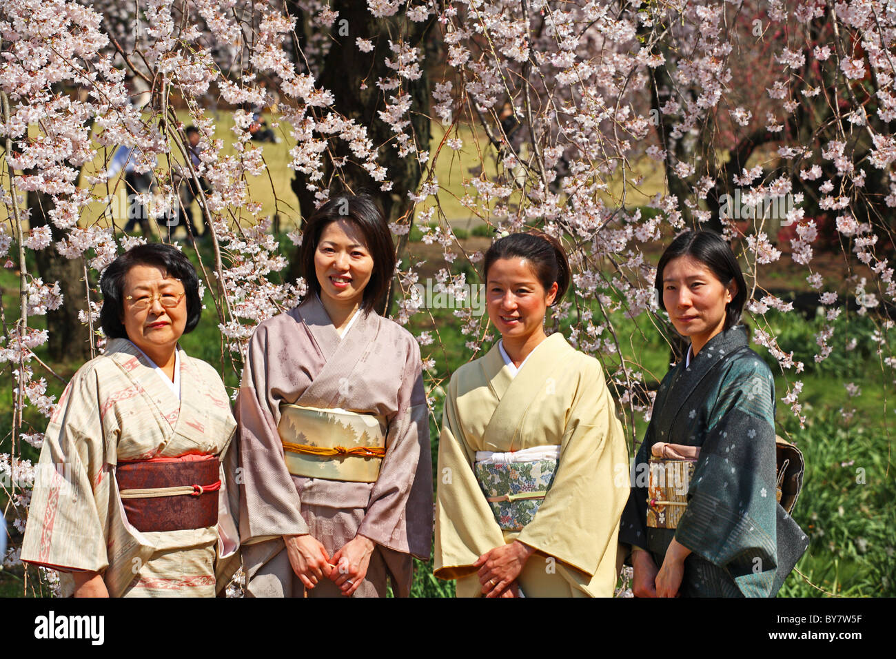 Japanese women in traditional costume posing for photographs beside ...