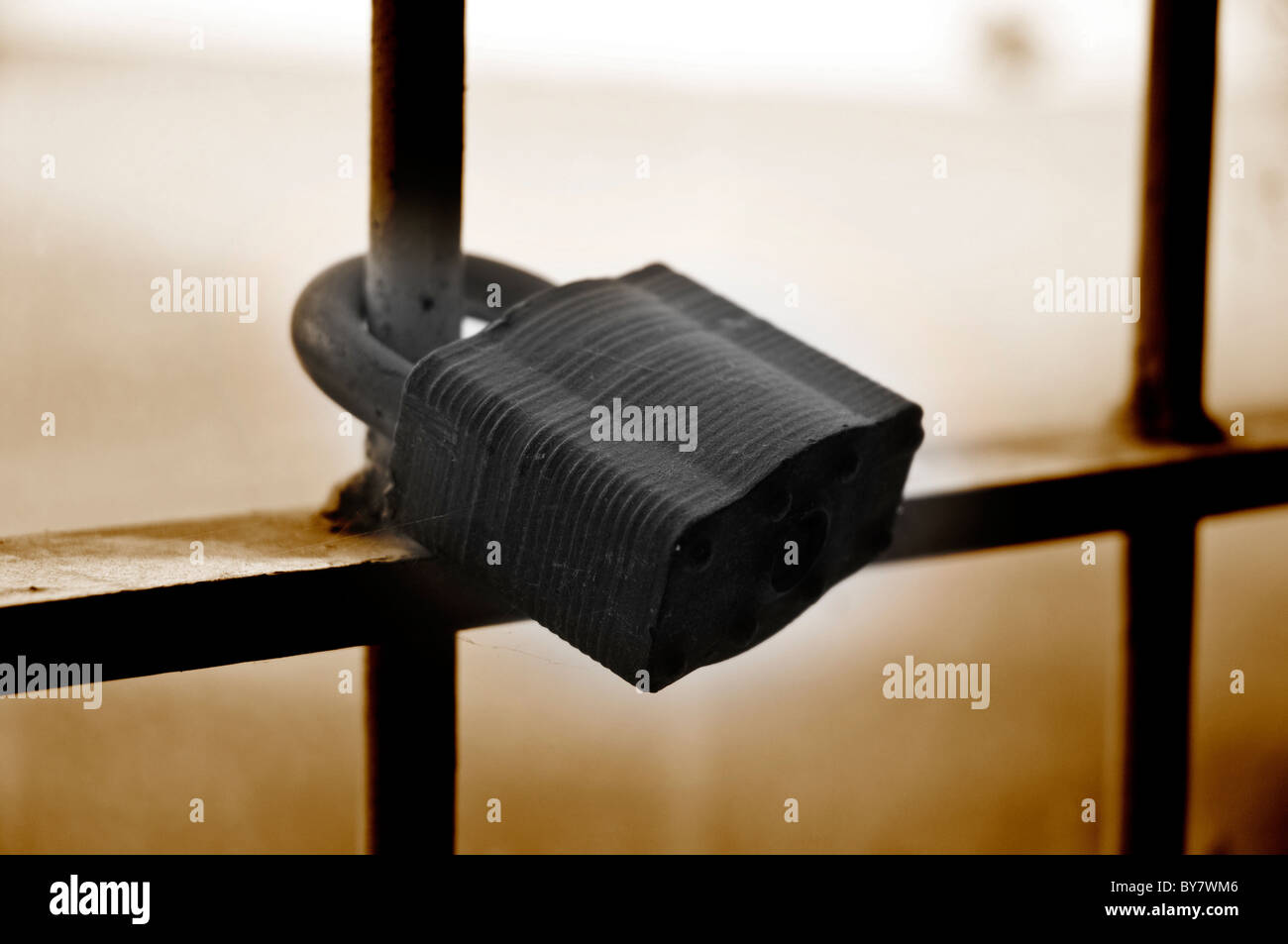 Padlock on window bars Stock Photo - Alamy