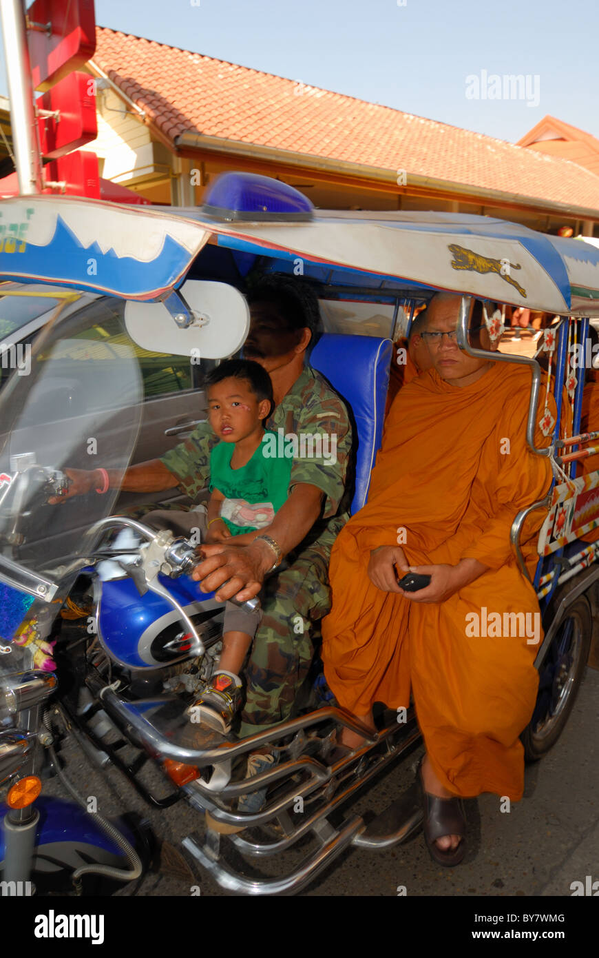 Thai monk on a Tuk-tuk at the Tha Sadet market at Nong Khai in Thailand ...