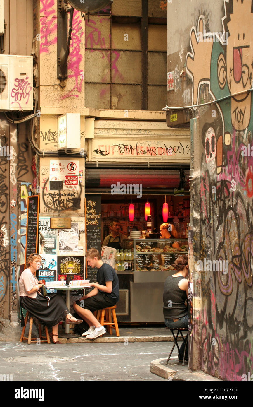 Small cafe located in Graffiti Alley showing a couple reading the cafe ...