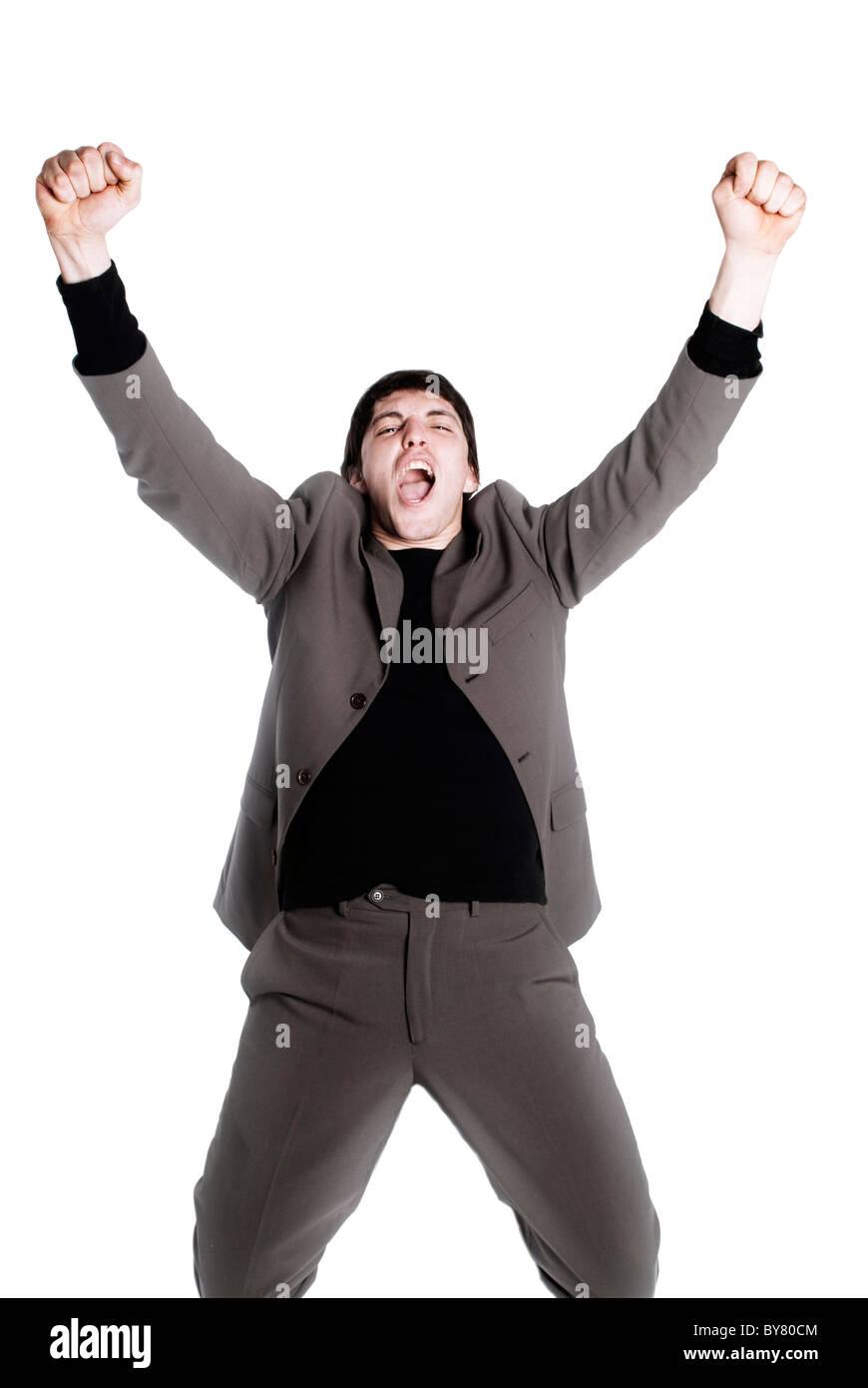 young businessman with hands up and face of victory, happy, elated ...