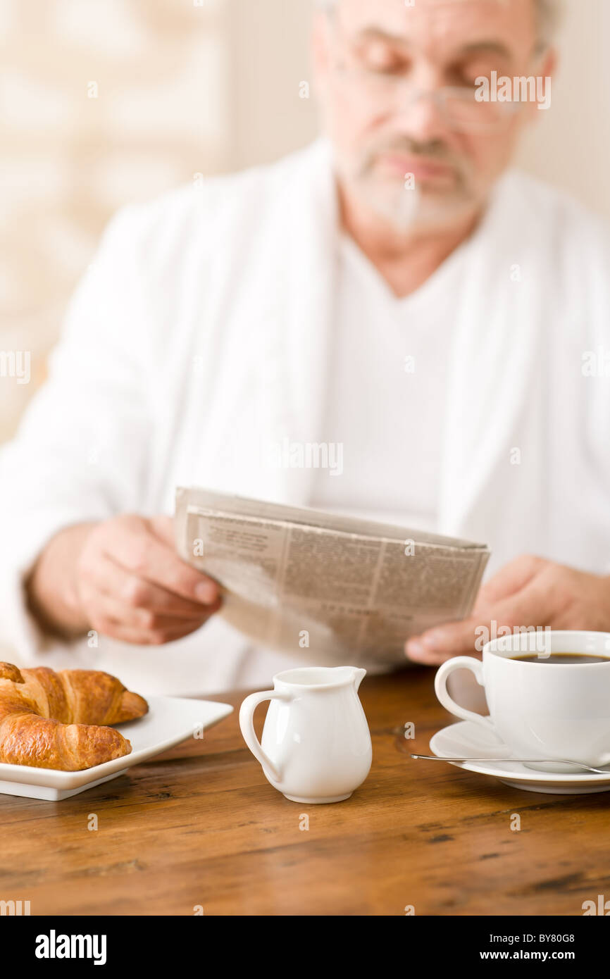Senior mature man having breakfast, coffee, croissant Stock Photo - Alamy