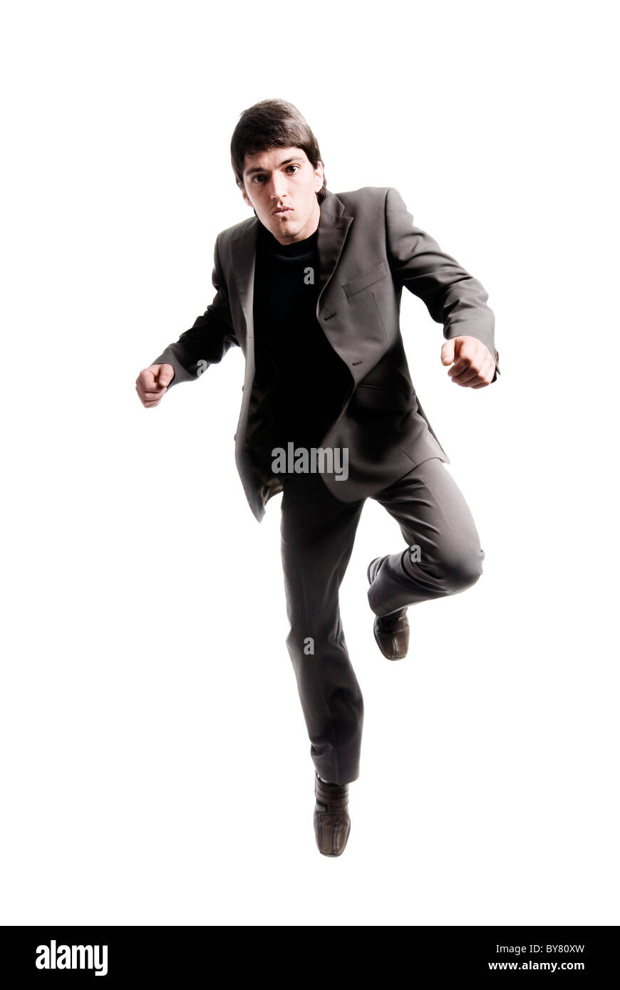 Businessman jumping in air, arms outstretched, looking at camera Stock ...