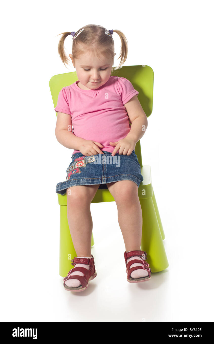 the little child sits on a chair Stock Photo - Alamy