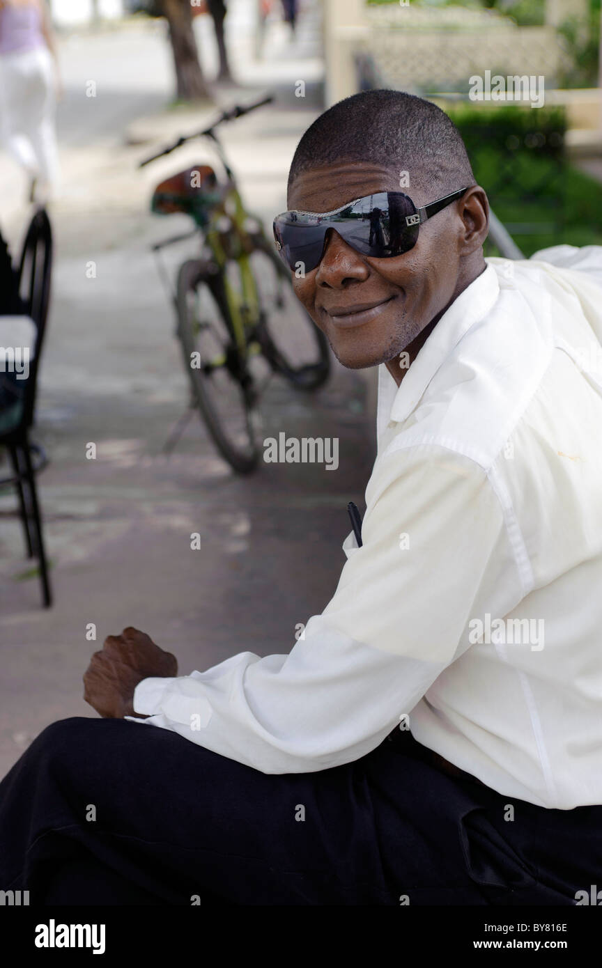 Portrait of Cuban man wearing sunglasses and white shirt in Holguin ...