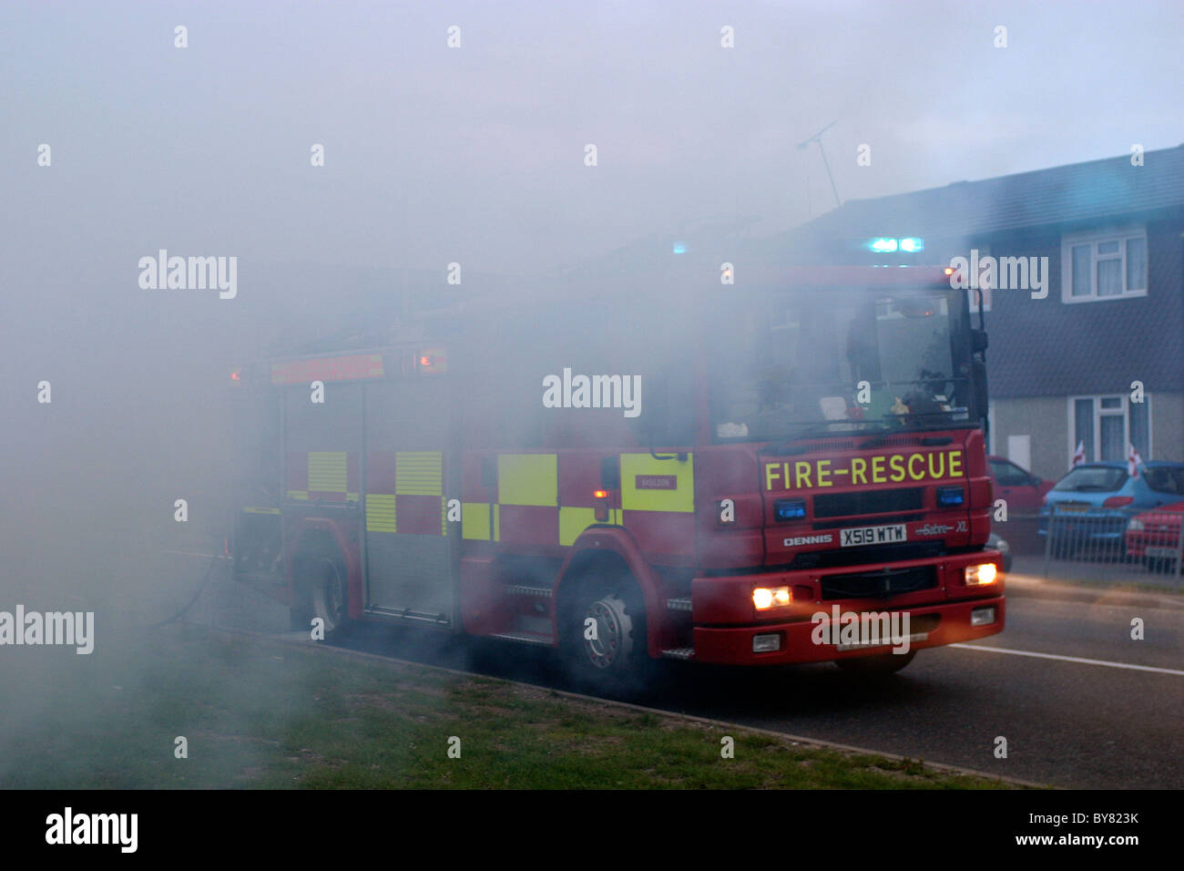 Fire engine masked by smoke Stock Photo - Alamy