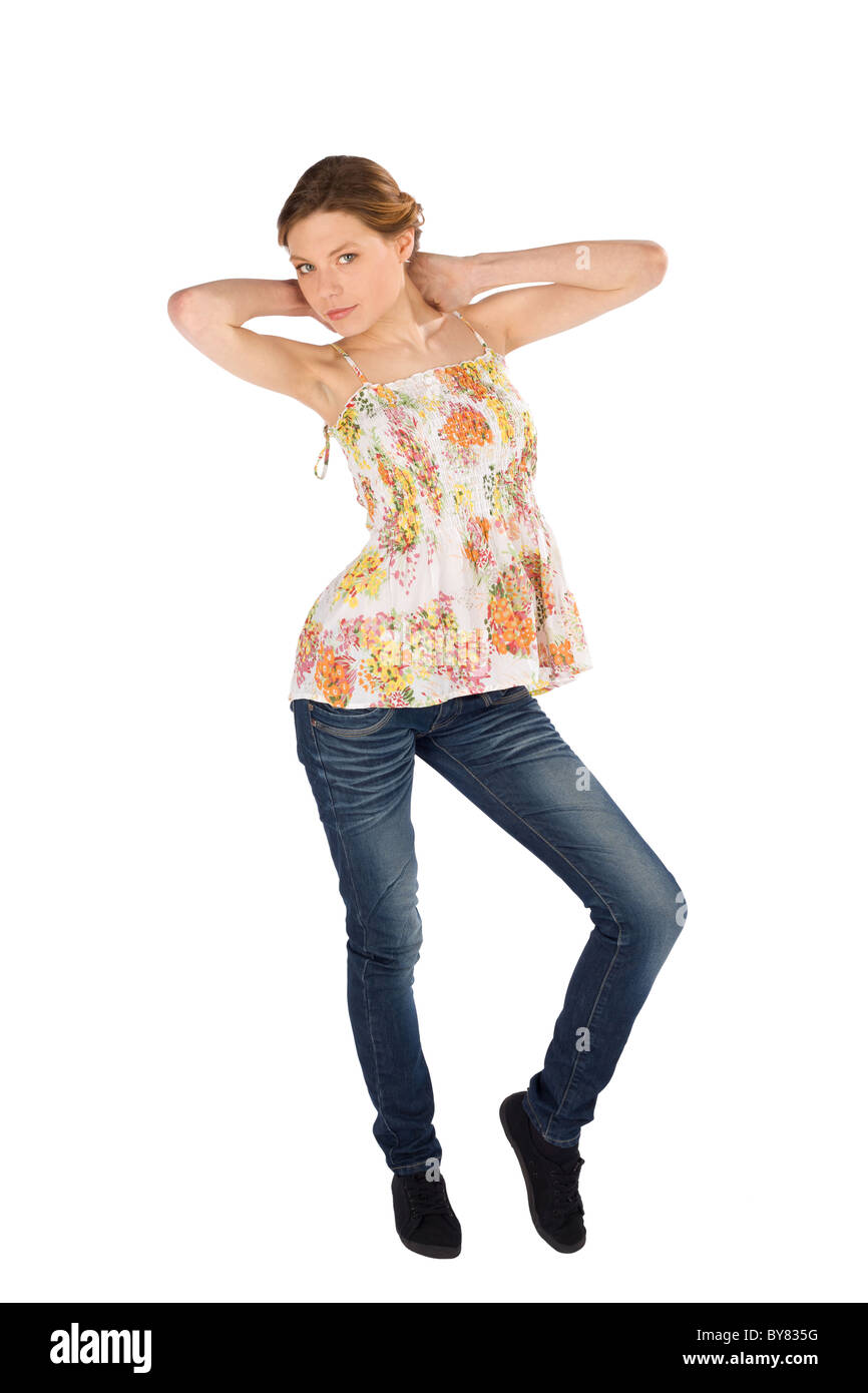 Attractive casual slim young woman with hands on neck pose standing on ...