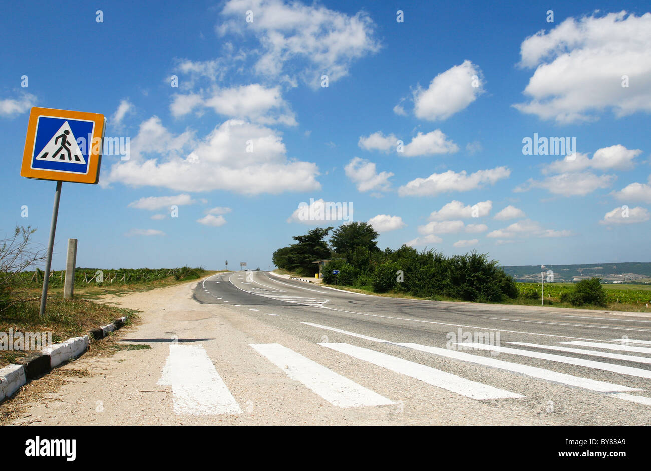 Pedestrian crossing with a sign on a country road Stock Photo - Alamy