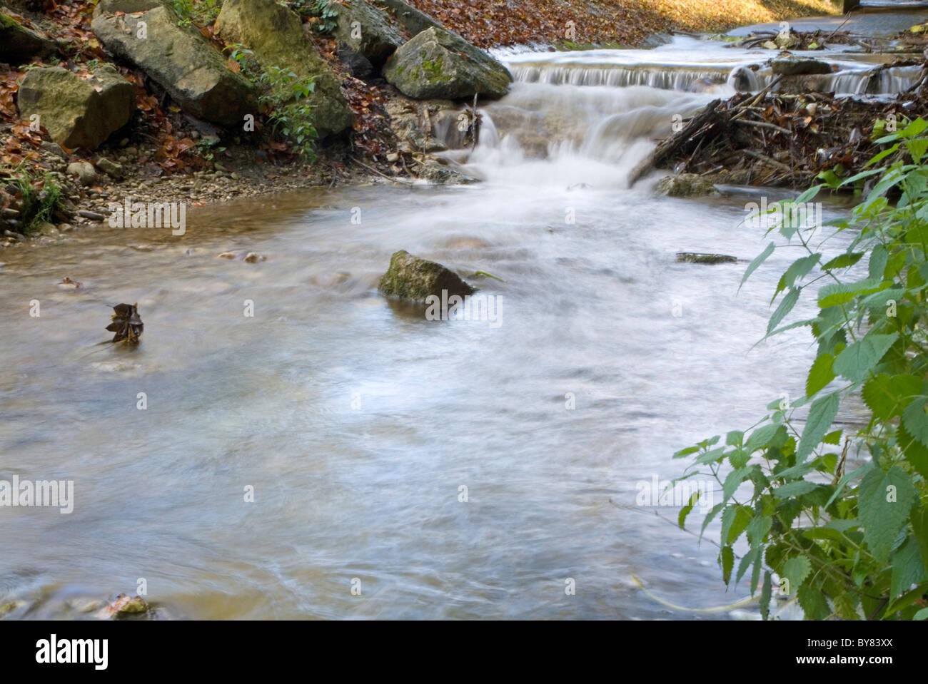 Shallow waterfall over rocks in a river Stock Photo - Alamy