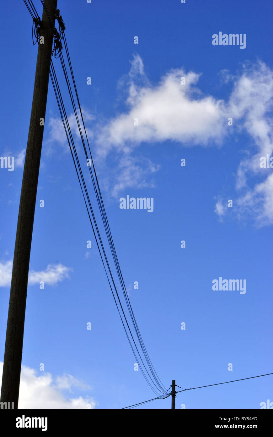 low voltage power line with blue sky background Stock Photo - Alamy
