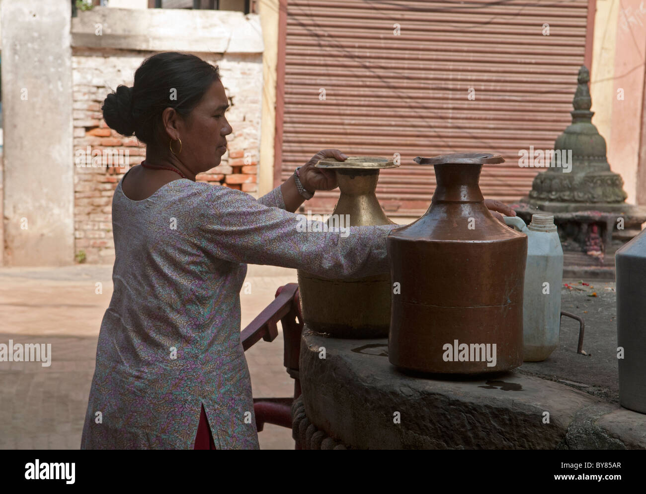 woman getting water at the communal tap in Kathmandu, Nepal Stock Photo ...