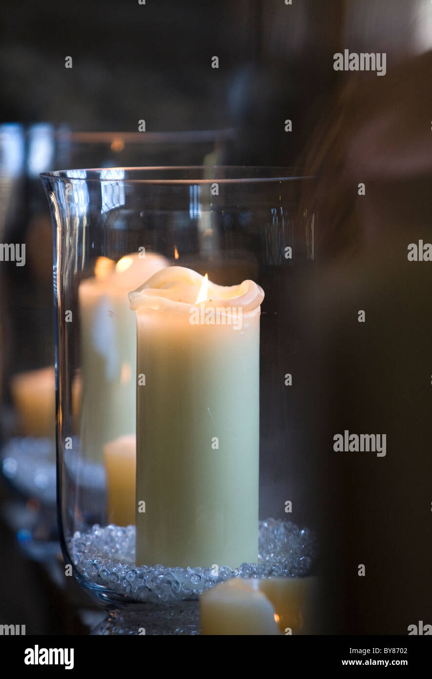 Lit candle in clear glass vase Stock Photo - Alamy