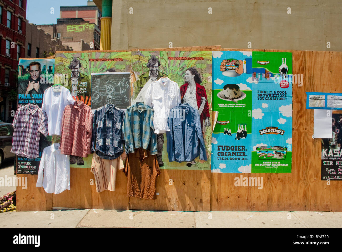 Sidewalk clothes vendor and advertisements Stock Photo - Alamy