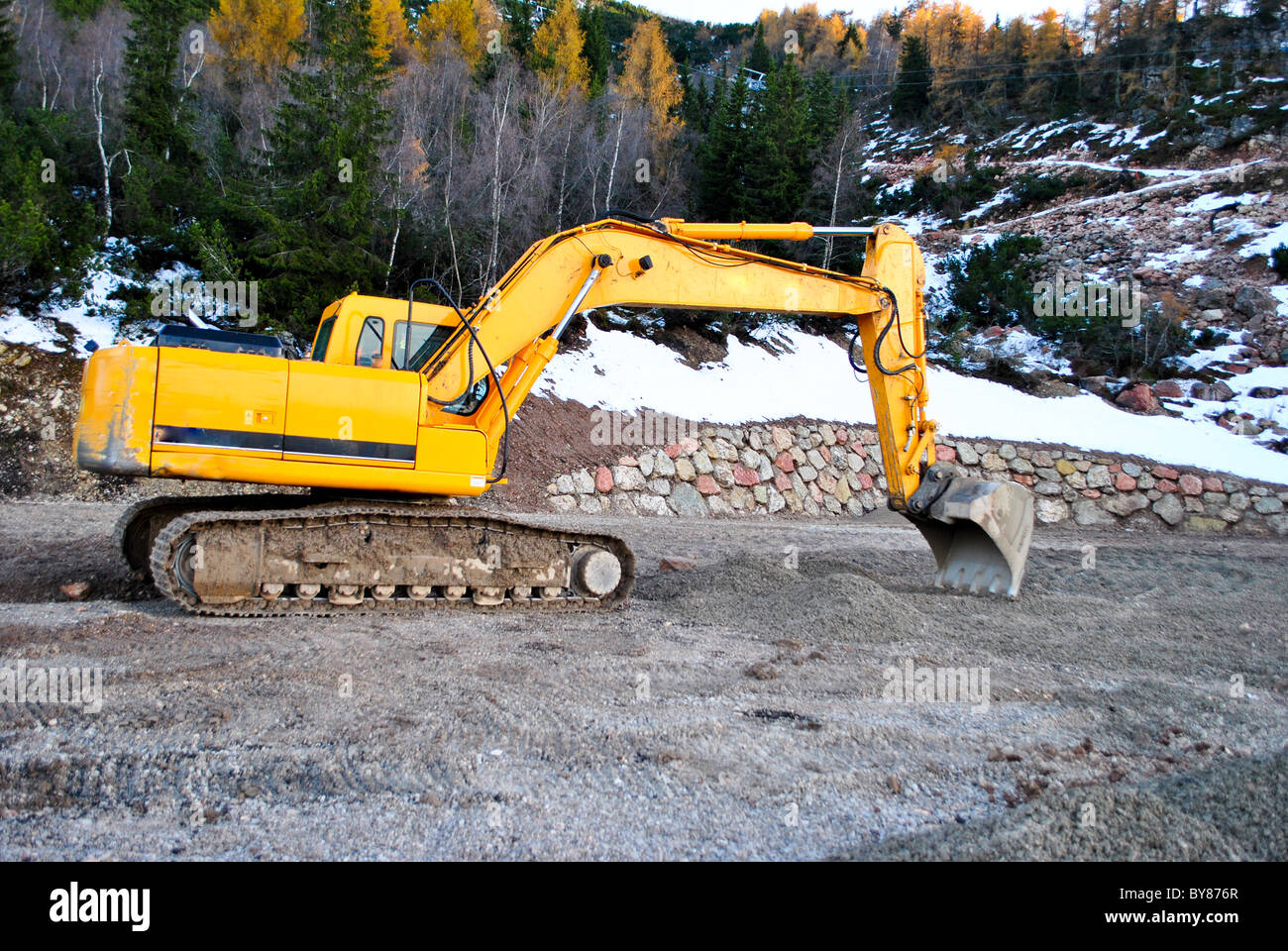 yellow excavator for road work Stock Photo - Alamy