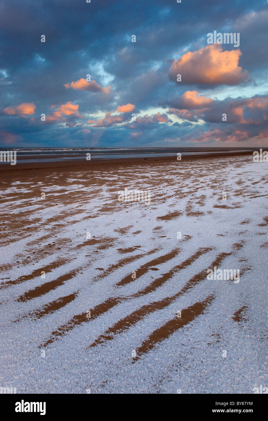Snow covering the sand dunes and beach at Holkham bay on the Norfolk ...