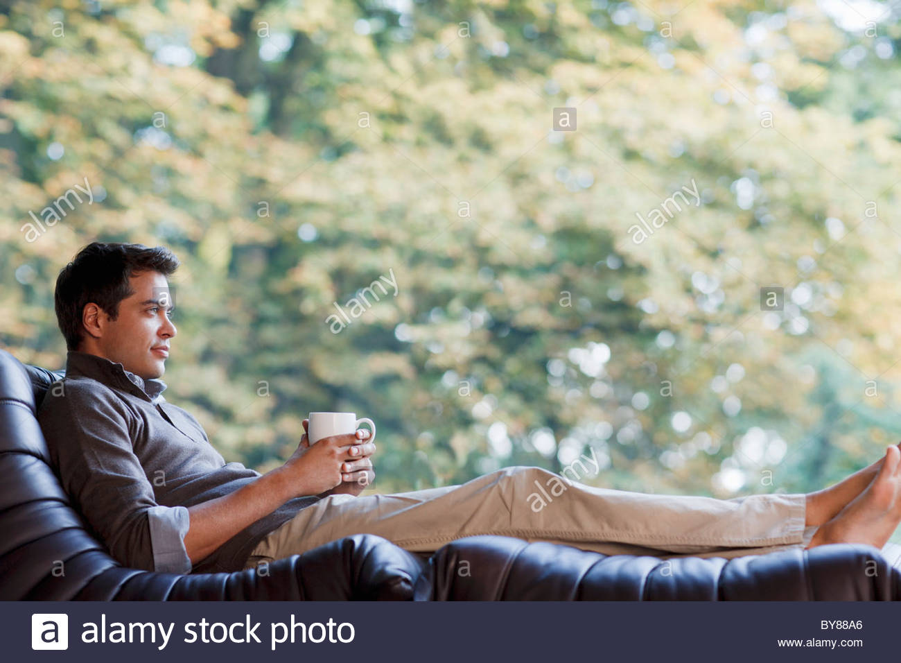 Man Laying On Lounge Chair Stock Photos & Man Laying On Lounge Chair ...