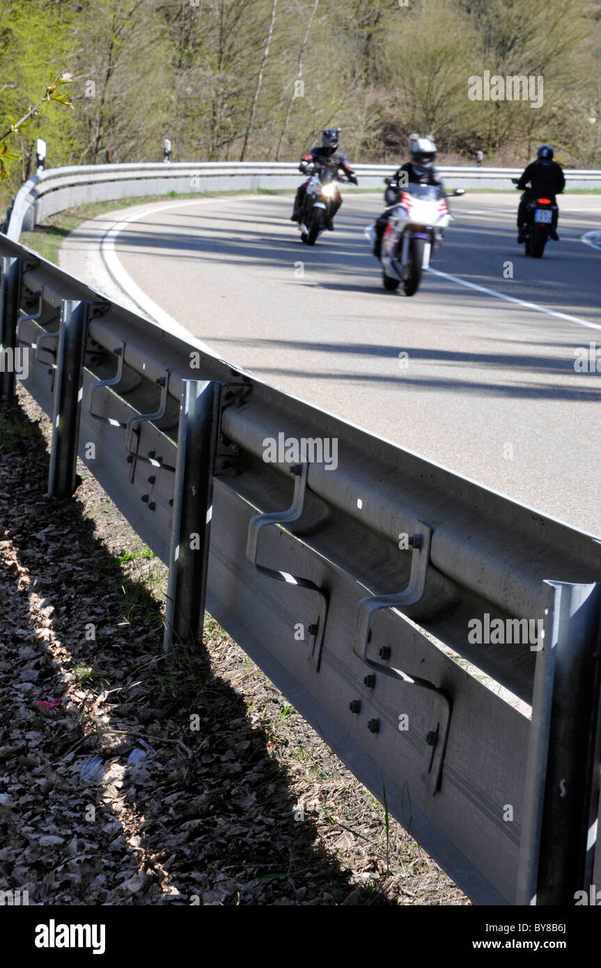 Motorcycle rider on country road with crash barrier protection Germany ...