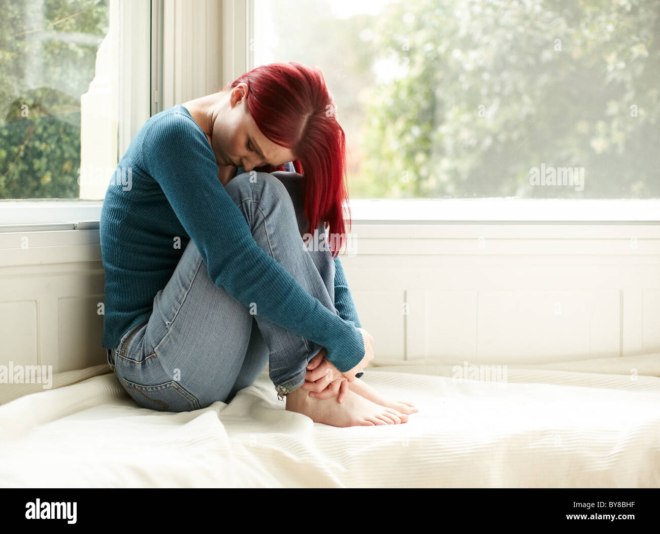 Woman Sad Alone Sofa High Resolution Stock Photography and Images - Alamy