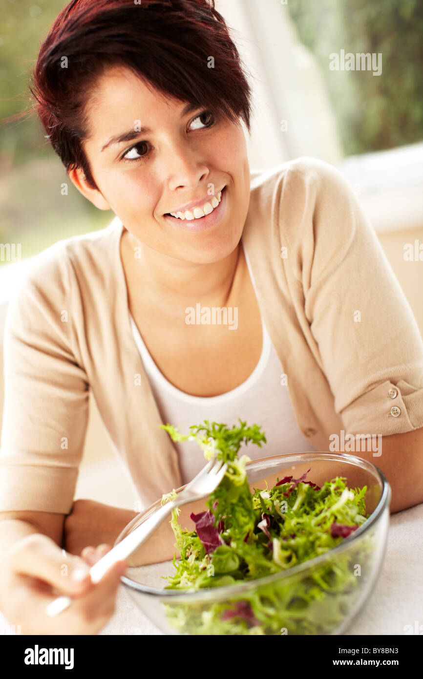 Girl eating salad Stock Photo - Alamy