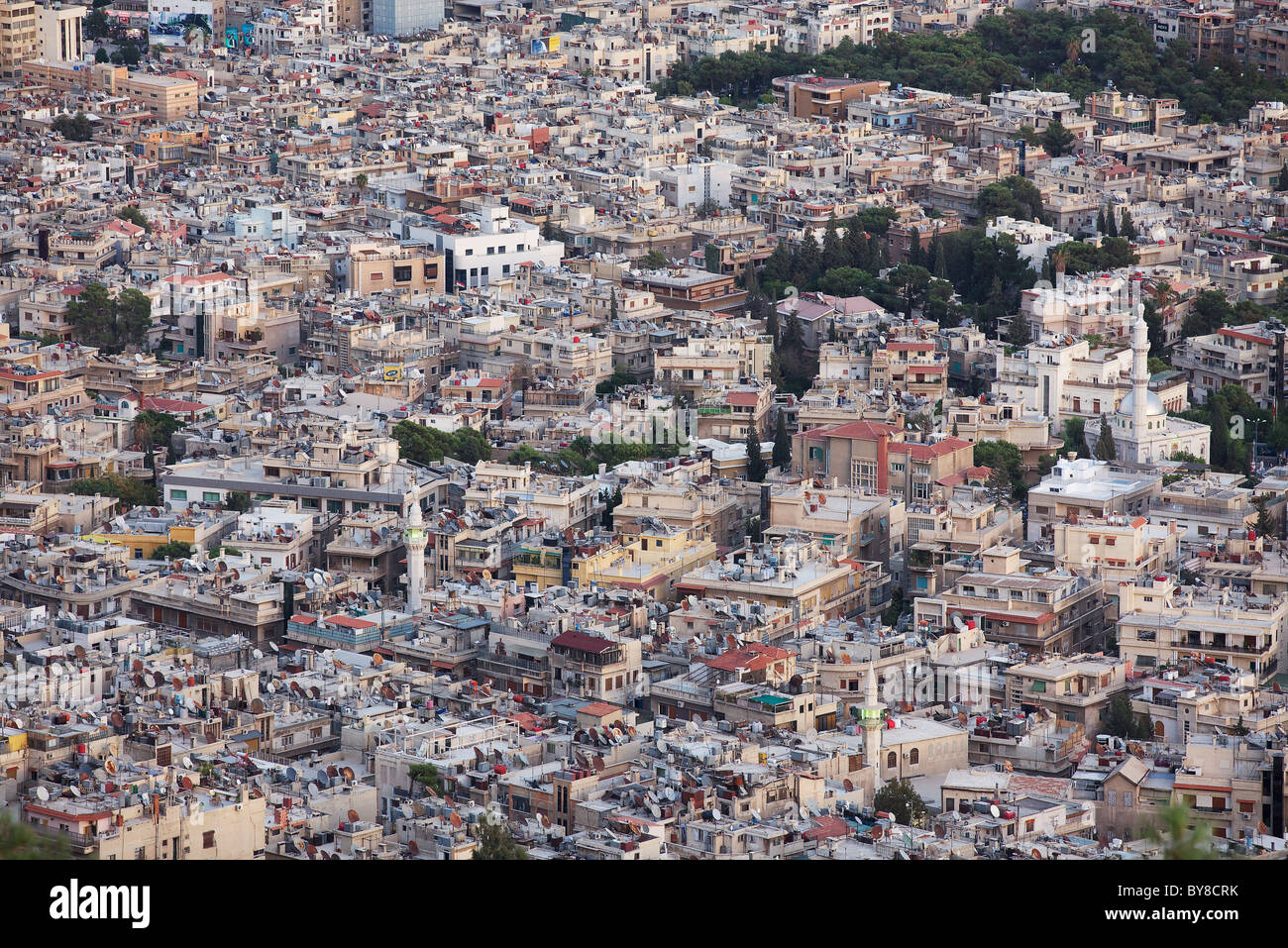 Damascus rooftops, covered with satellite dishes, with three minarets ...