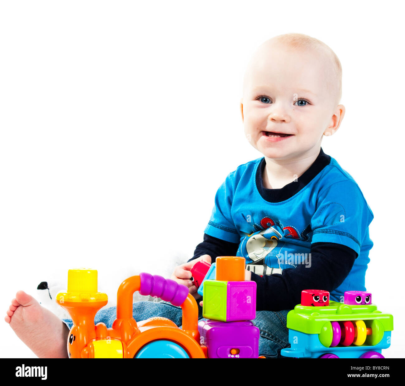 Baby boy playing with the train isolated on white Stock Photo - Alamy