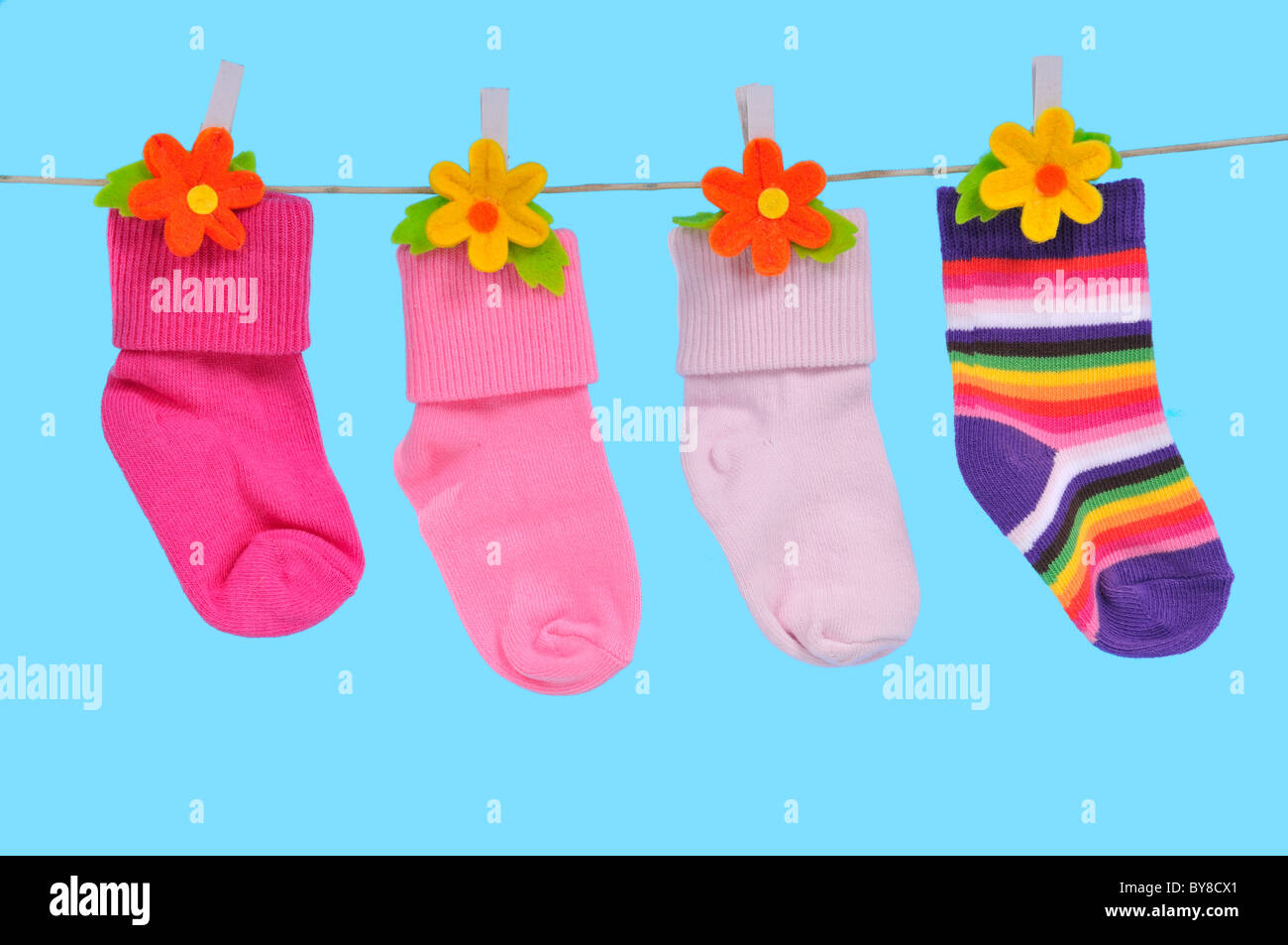 Four Colorful Socks Drying on a String Stock Photo - Alamy
