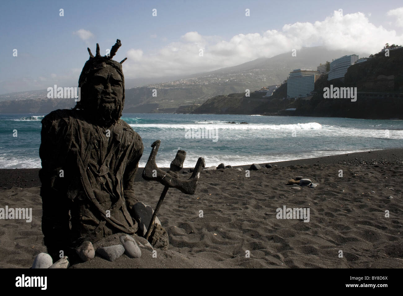 Tenerife beach. Sand sculpture of a Guanche Poseidon style native ...