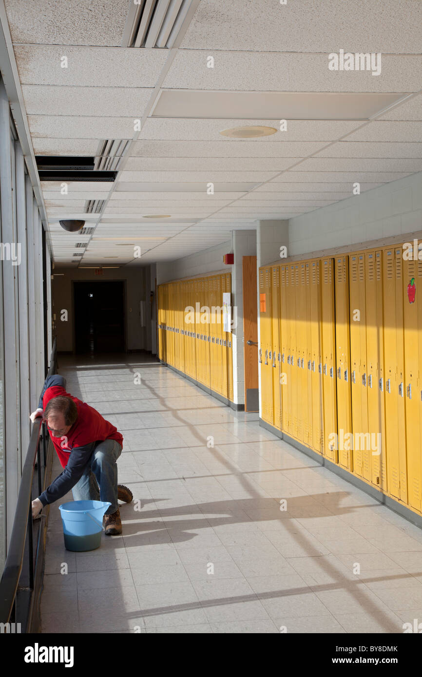 Volunteer Cleans School Hallway Stock Photo - Alamy