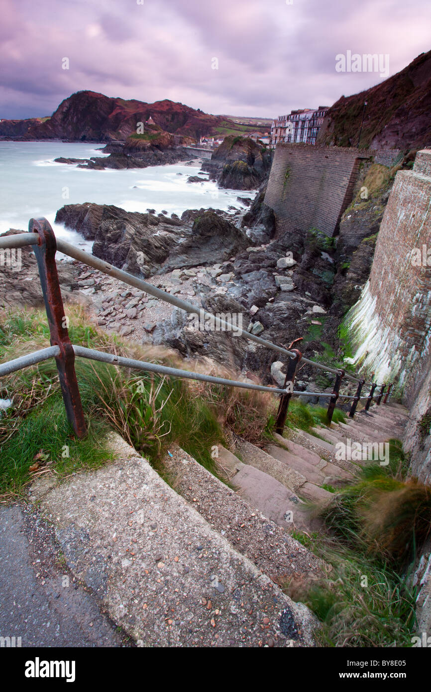Concrete steps leading down to a rocky beach Stock Photo - Alamy