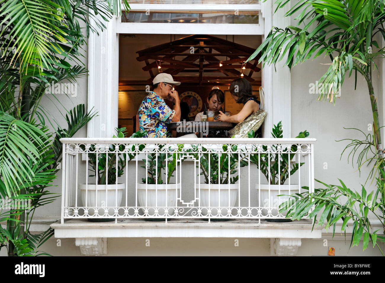 Diners look out window in Restaurant on Kalakaua Ave along Waikiki ...