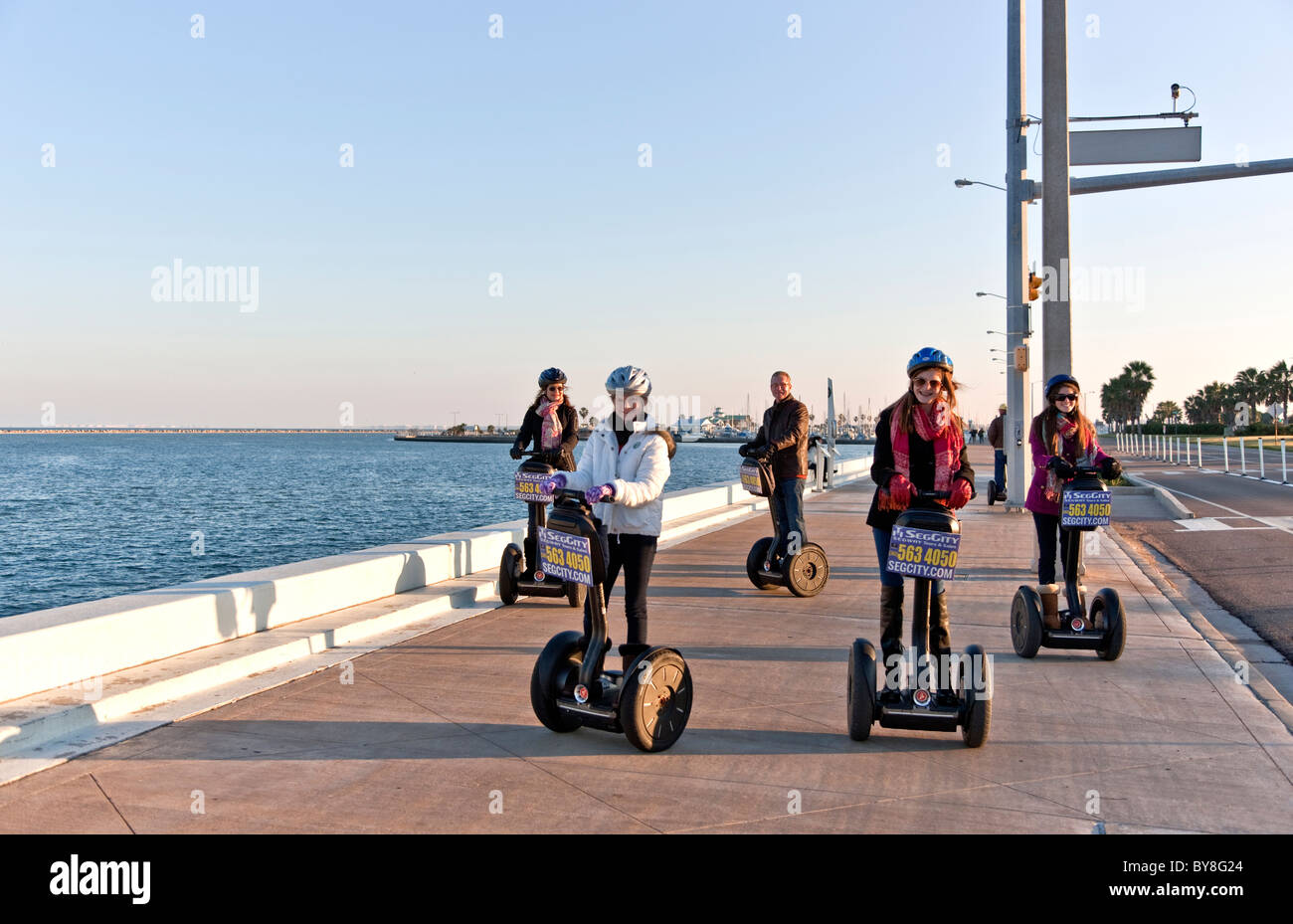 Family members operating 'Segways' Stock Photo - Alamy