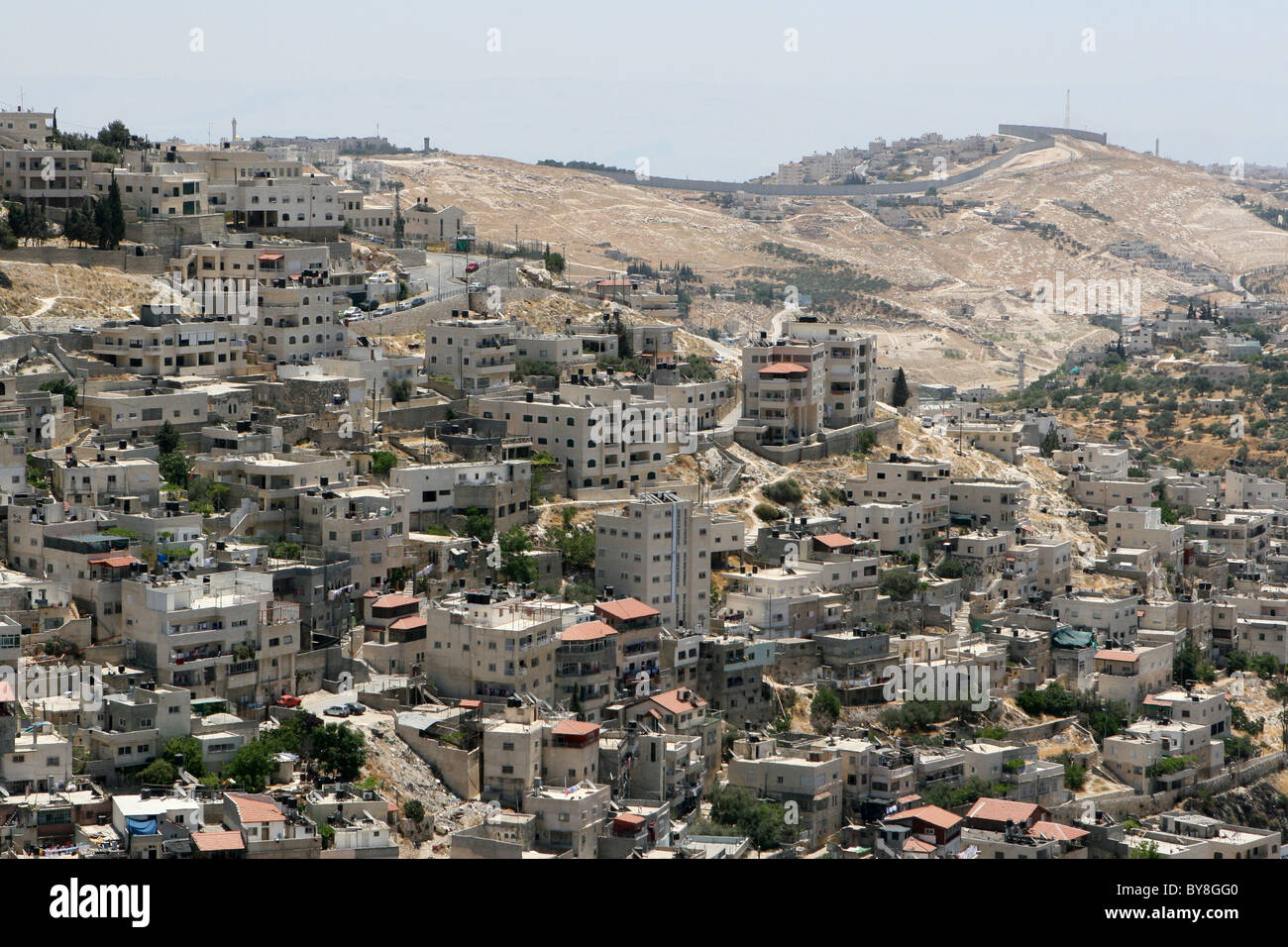 Homes and apartment buildings are scattered across the hillside just ...