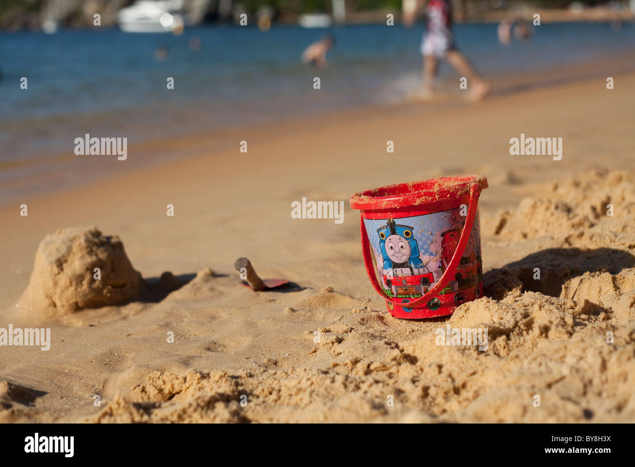 Bucket and sandcastle on beach Stock Photo - Alamy