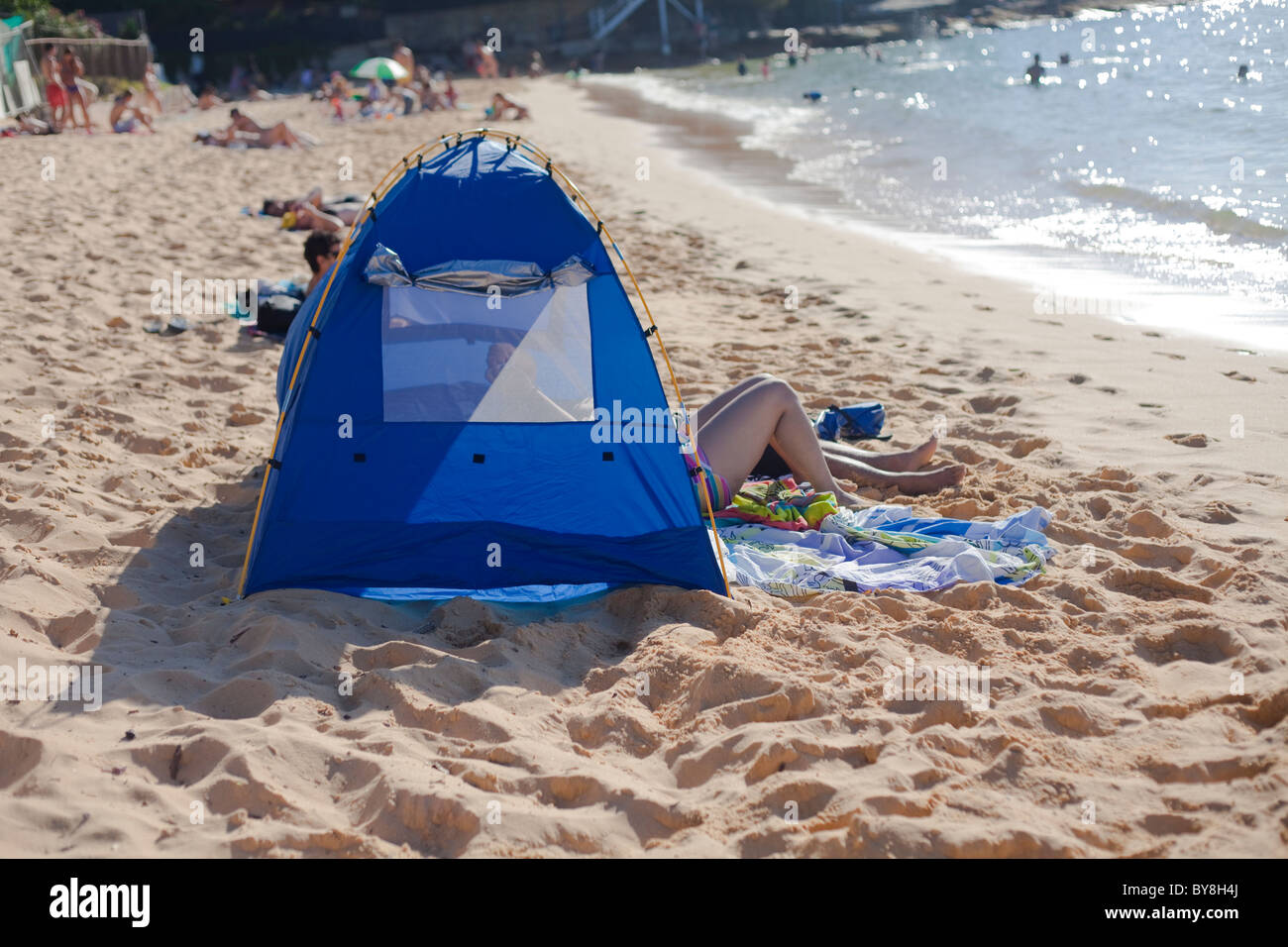 Sun bathers under a beach tent at Camp Cove in Sydney Stock Photo - Alamy
