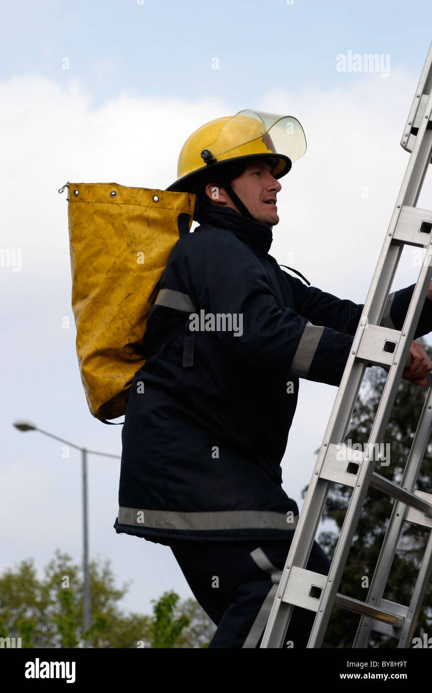 Fireman climbing a ladder hi-res stock photography and images - Alamy