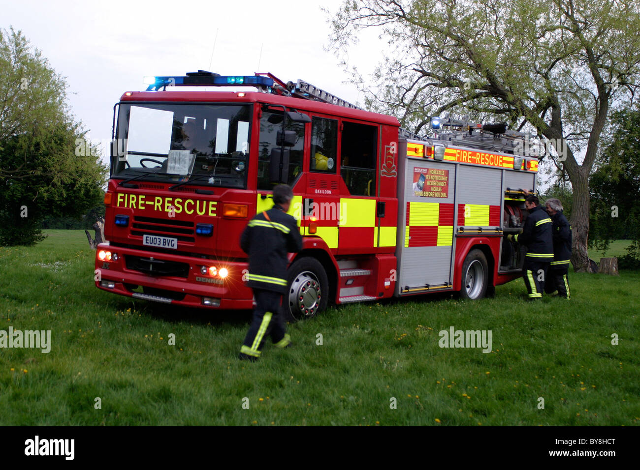 Fire engine in a field answering an emergency call Stock Photo - Alamy