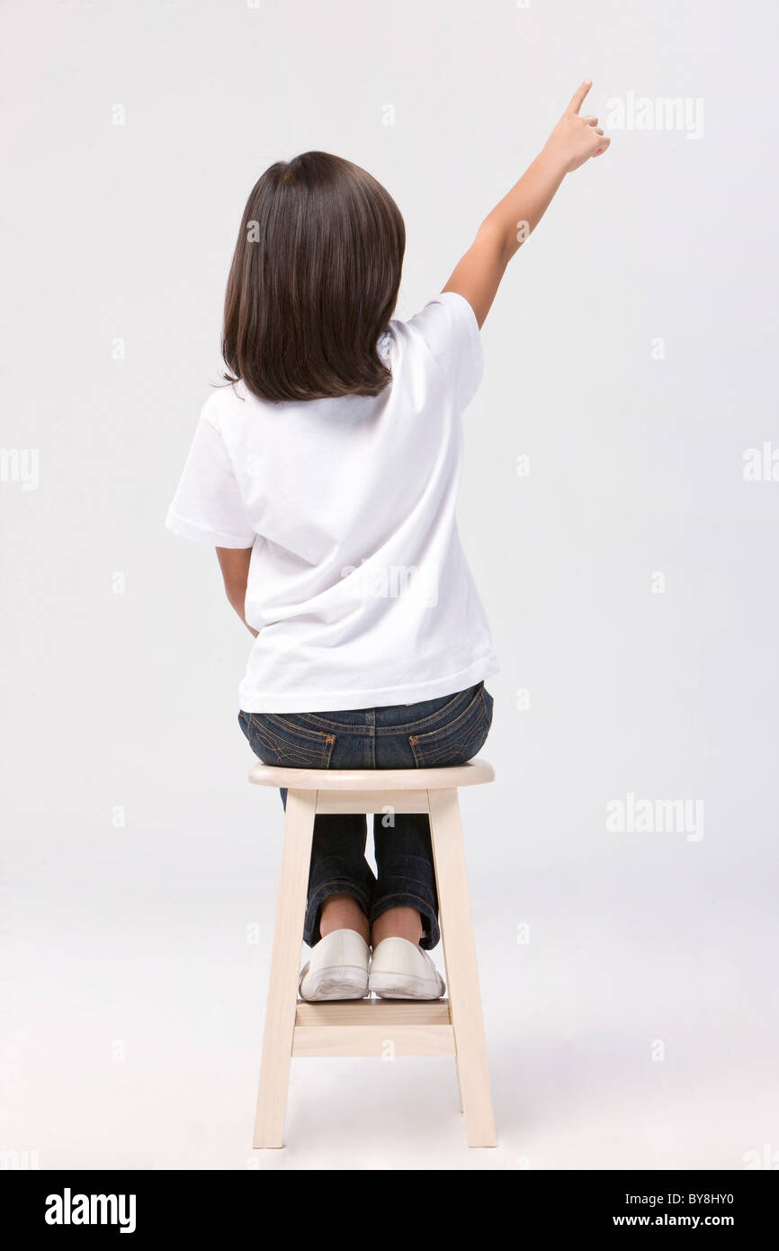 Girl sitting stool back hi-res stock photography and images - Alamy